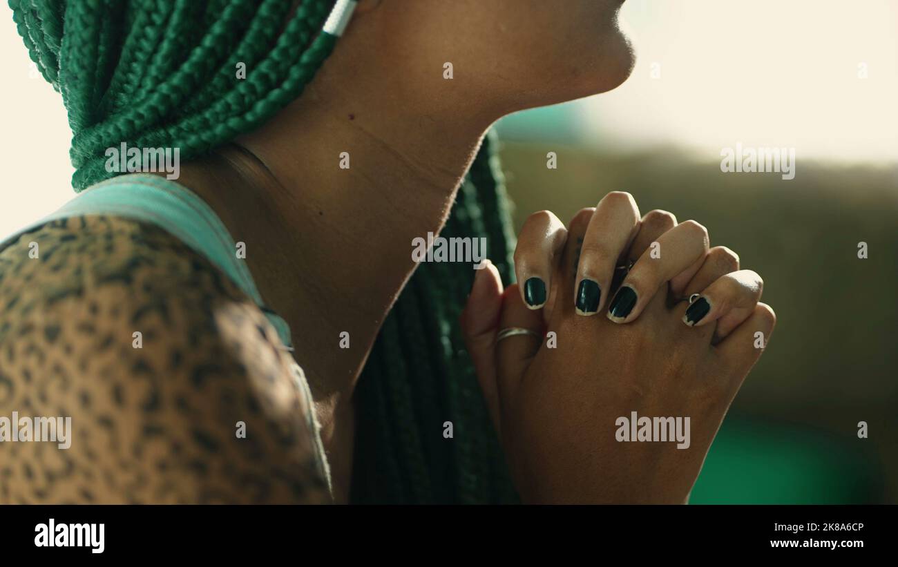 Closeup African American hands in prayer. One young black female adult ...