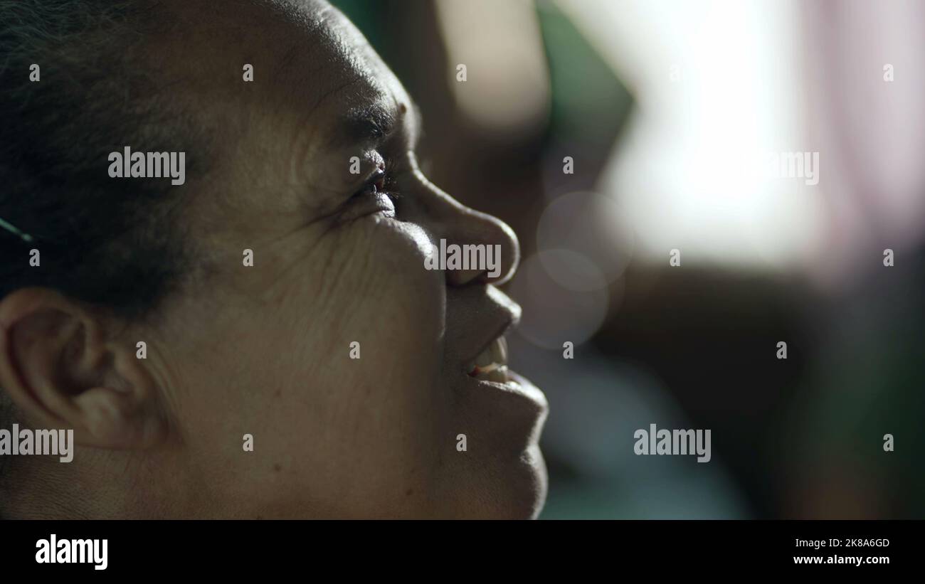 Meditative hispanic senior woman closing eyes in contemplation ...