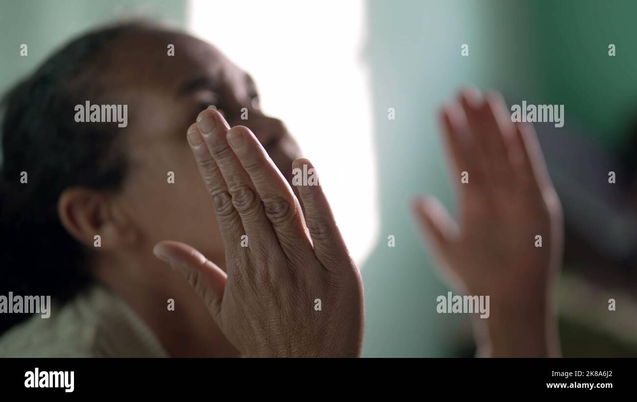 Older woman praying to God at home. One hispanic senior lady in prayer ...