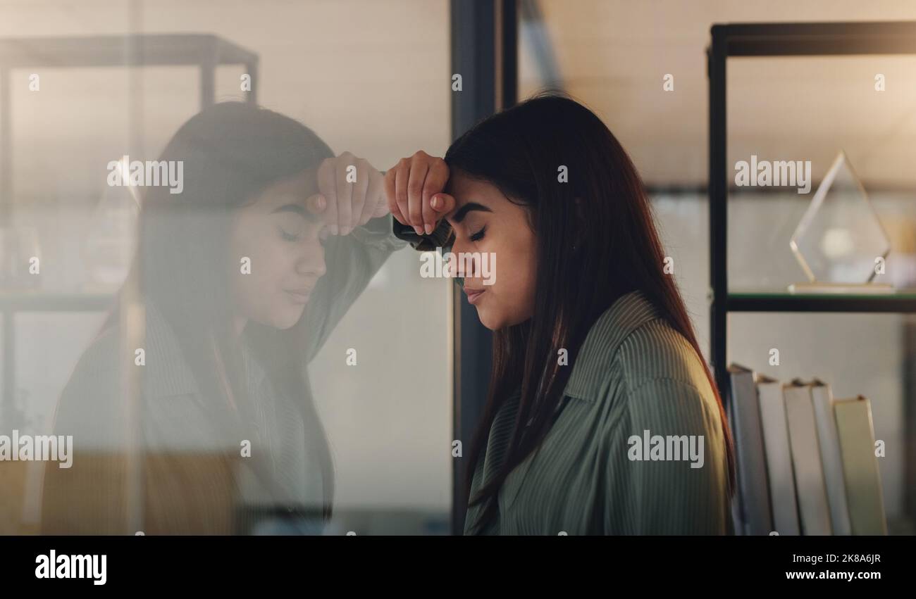 In a panic about her looming deadlines. a young businesswoman looking ...