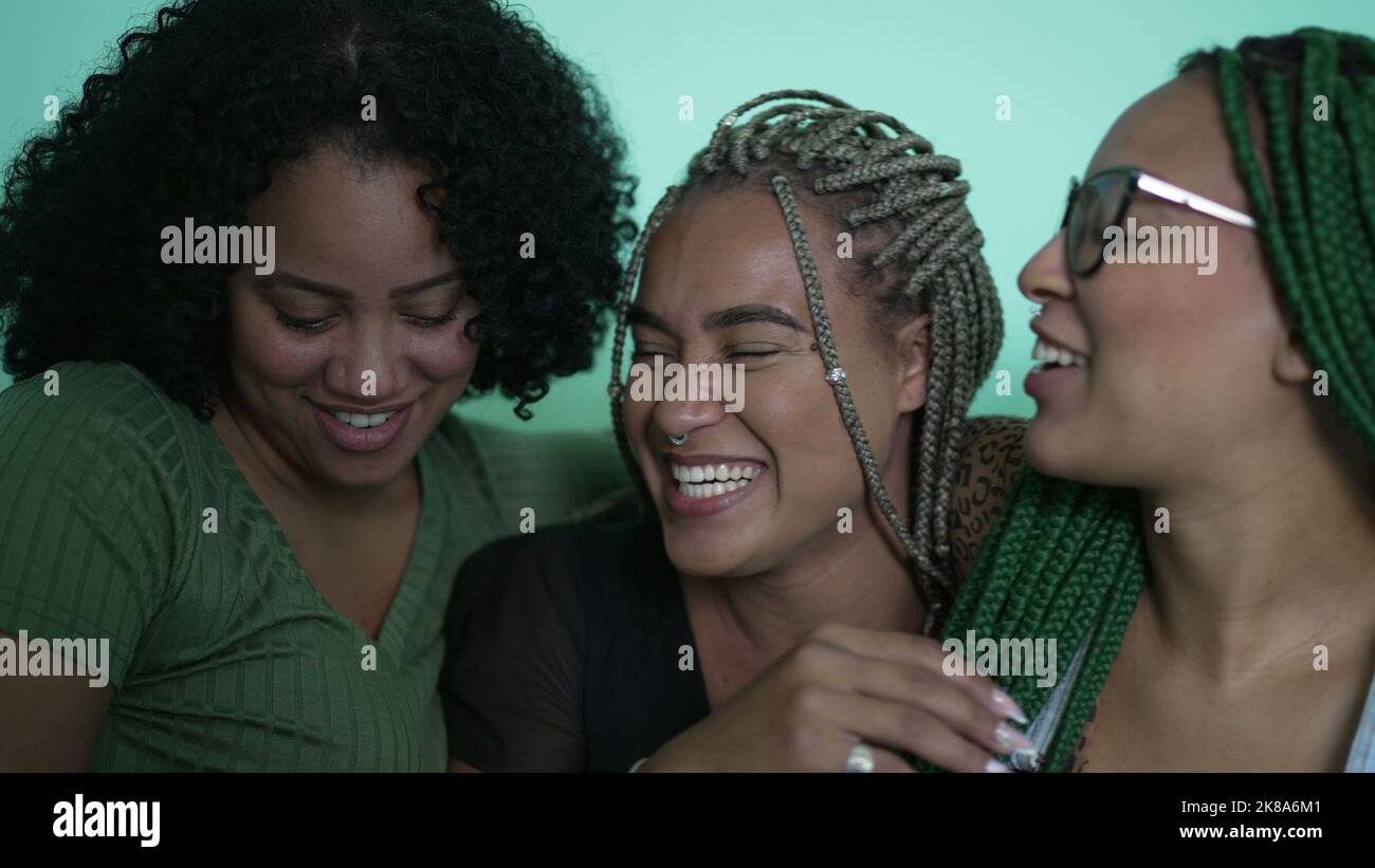 Happy female girlfriends laughing together three hispanic black latina ...