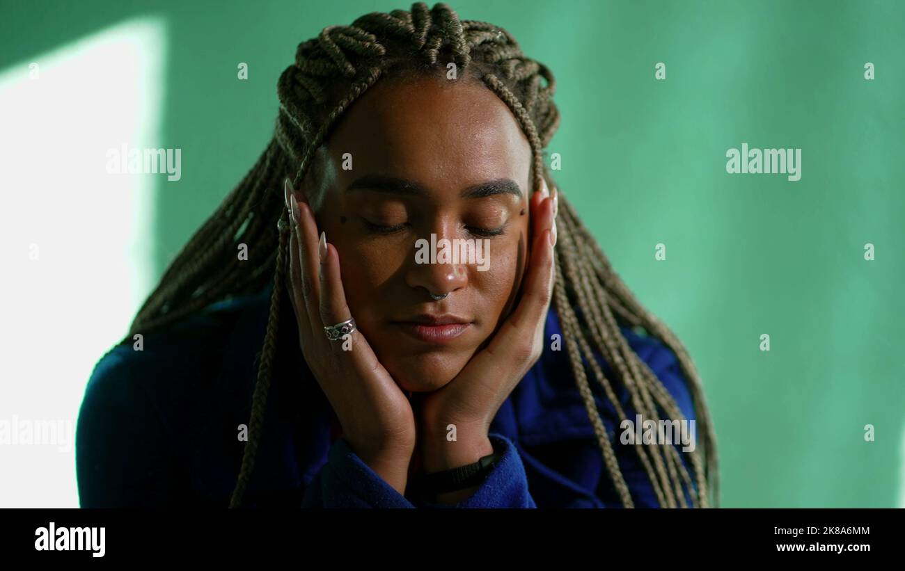 One sad African American young woman with heartbroken emotion. A ...