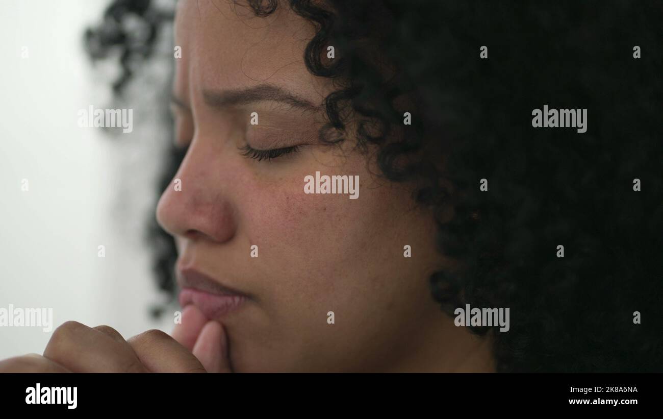 One spiritual young black woman face in prayer. Meditative ...