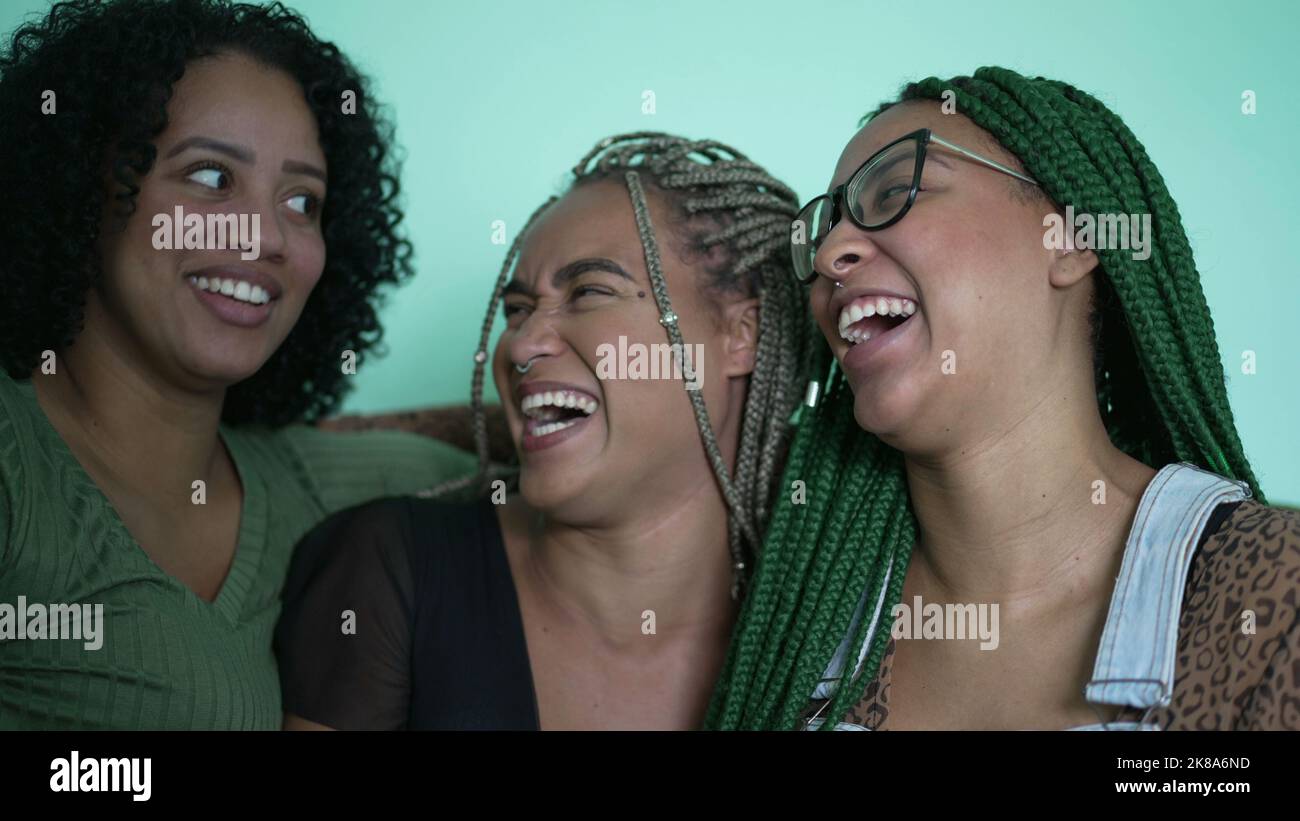 Happy female girlfriends laughing together three hispanic black latina ...