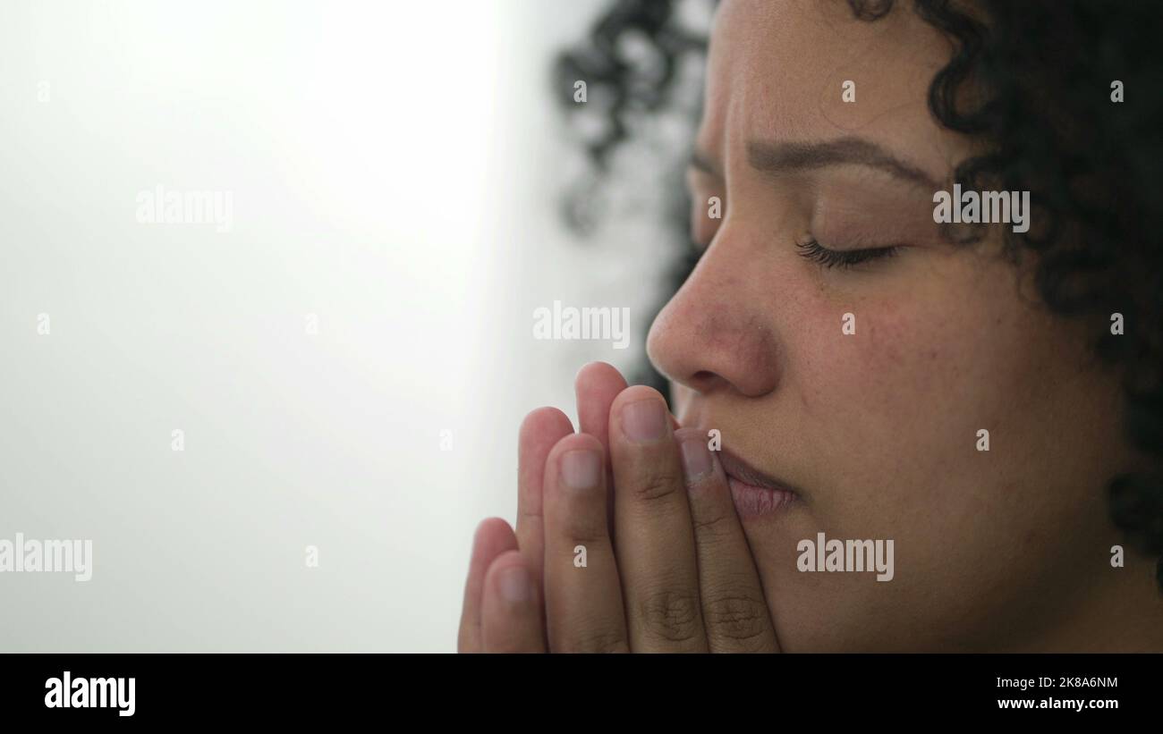 One spiritual young black woman face in prayer. Meditative ...