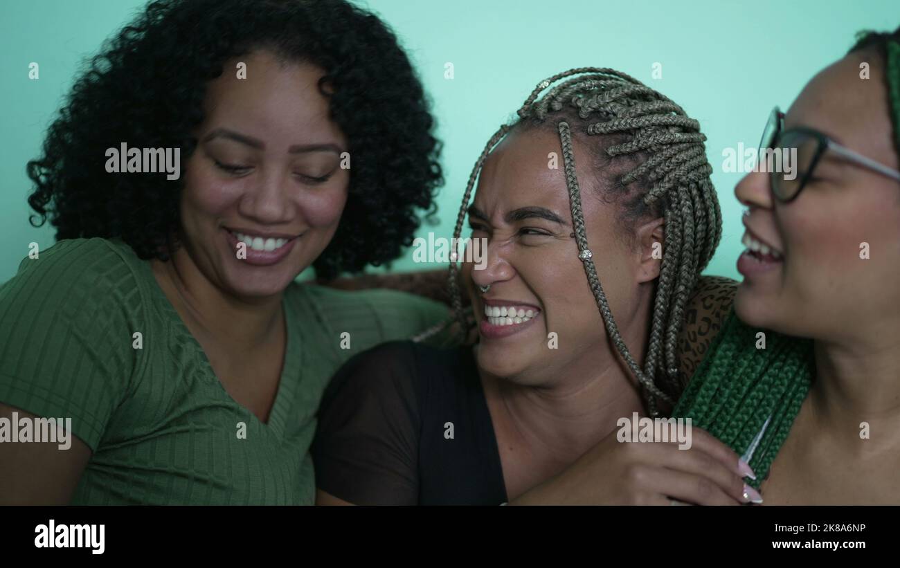 Happy female girlfriends laughing together three hispanic black latina ...