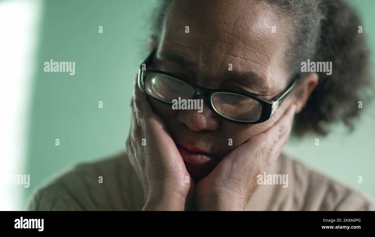 Pensive hispanic older woman closeup face with sad expression ...