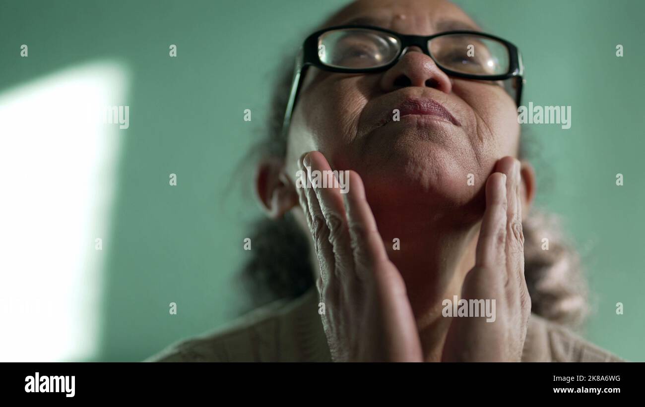 Religious older senior hispanic woman praying to God. Spiritual South ...