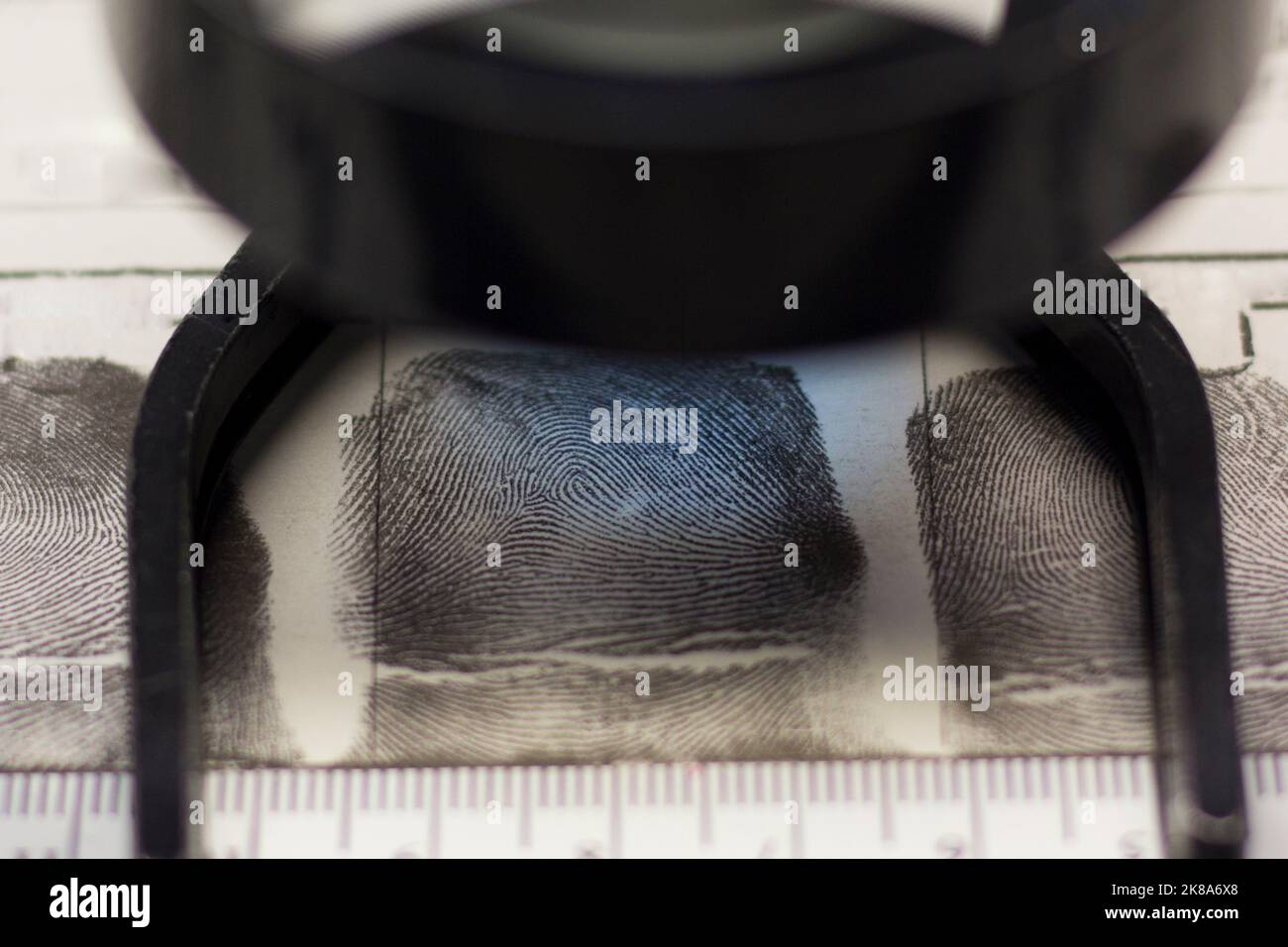 Lens, fingerprints and forensic ruler on fingerprint card Stock Photo ...