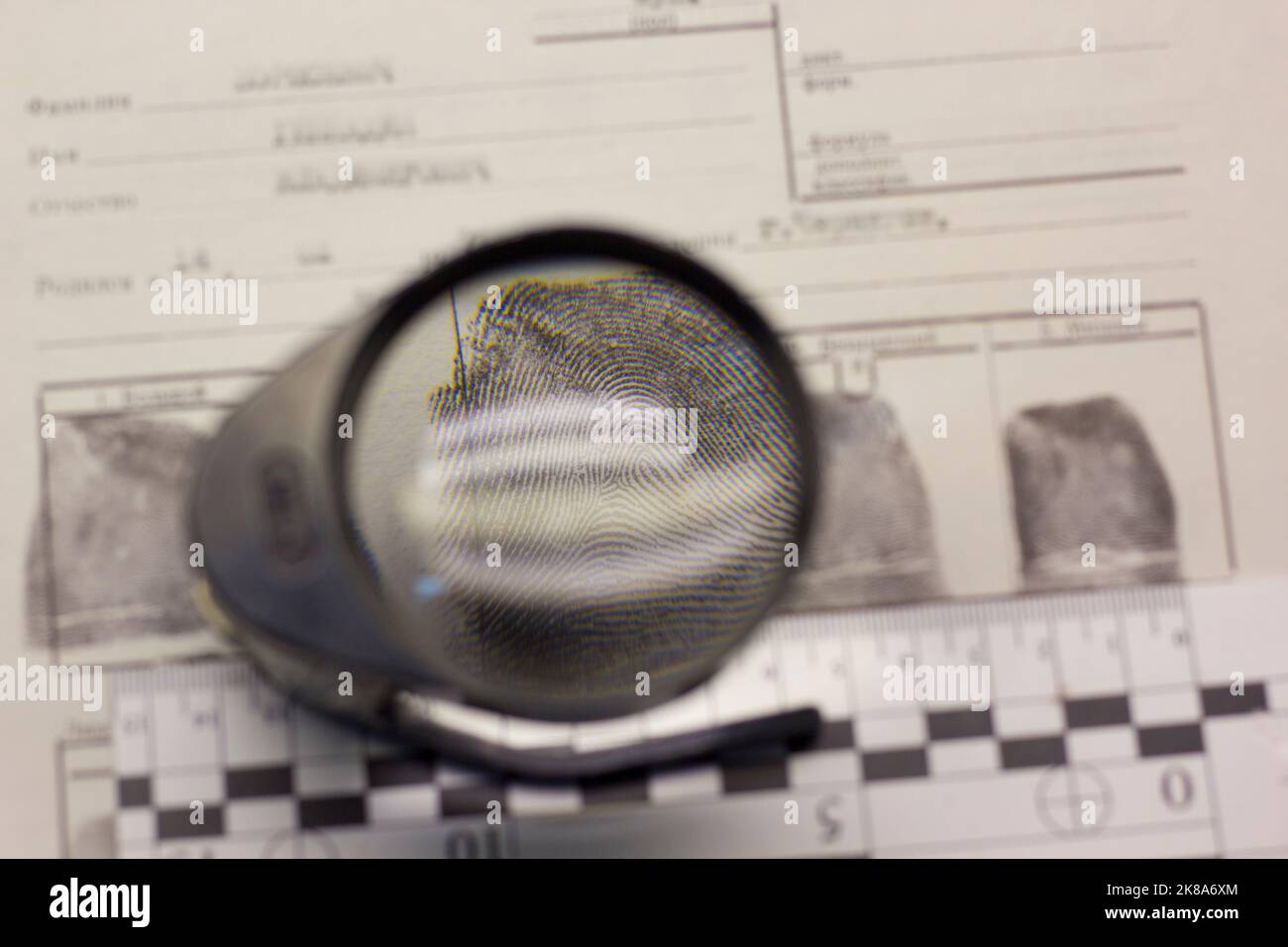 Lens, fingerprints and forensic ruler on fingerprint card Stock Photo ...
