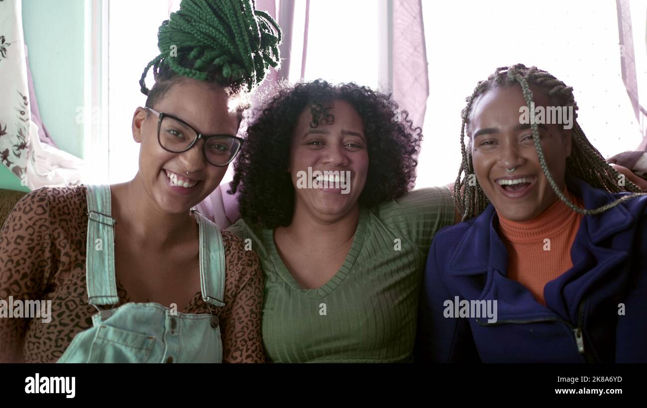 Three happy carefree Brazilian young black women laughing and smiling ...
