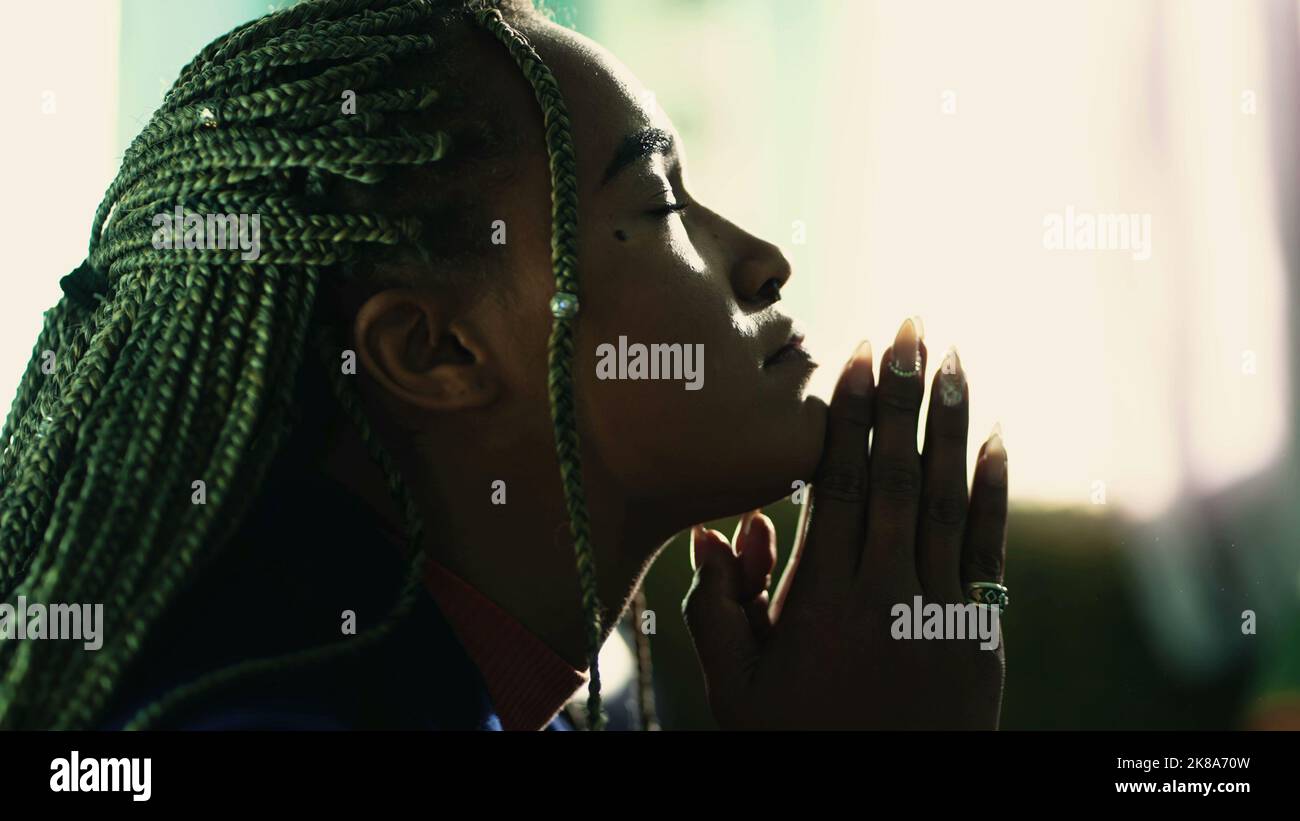 Spiritual African American praying to God. A religious black hispanic ...