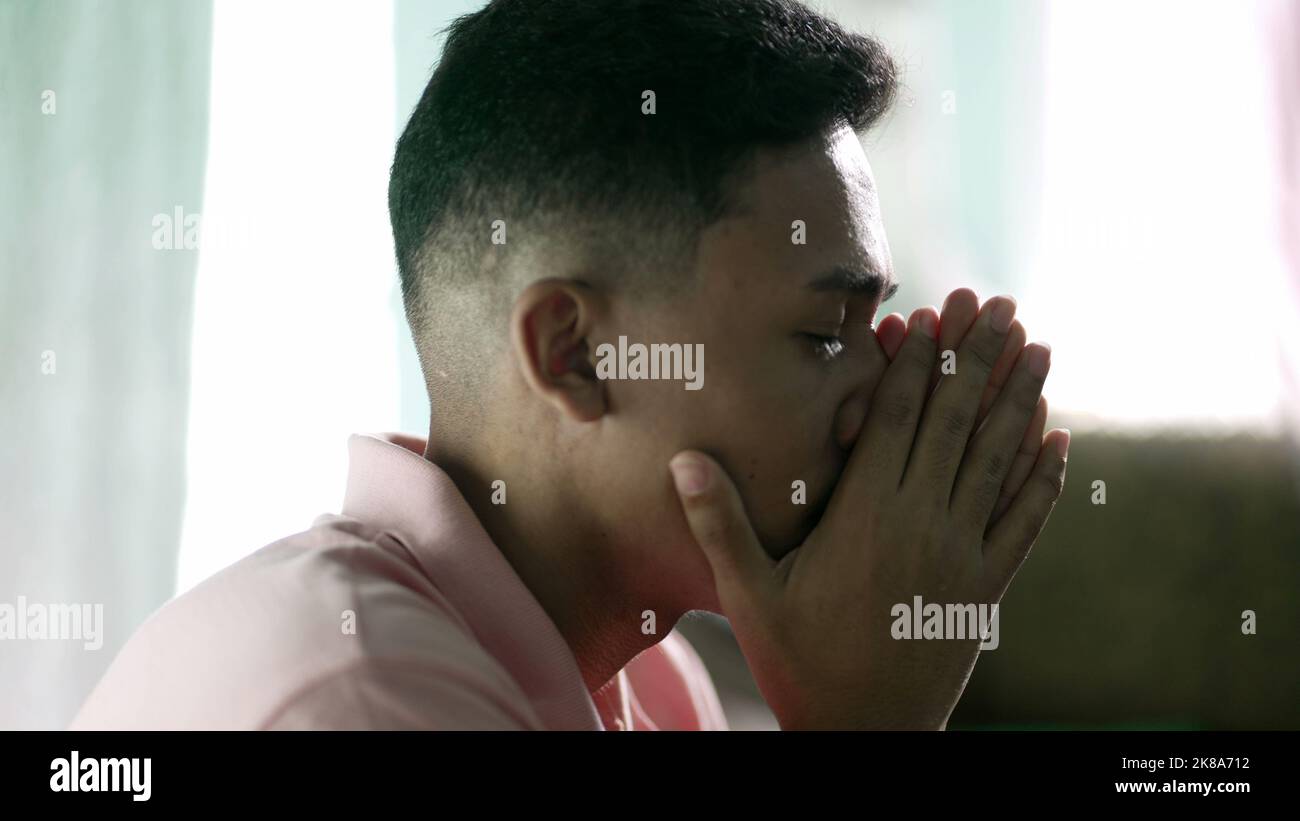 South American hispanic man begging to God for help and divine support ...