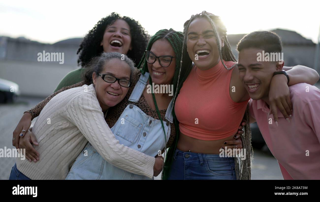 A black family embrace. Group of South American hispanic people hugging ...