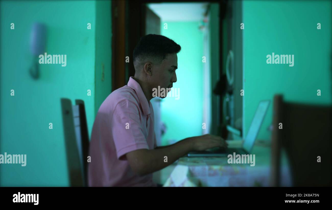 One hispanic man in front of laptop computer. Latin person browsing ...
