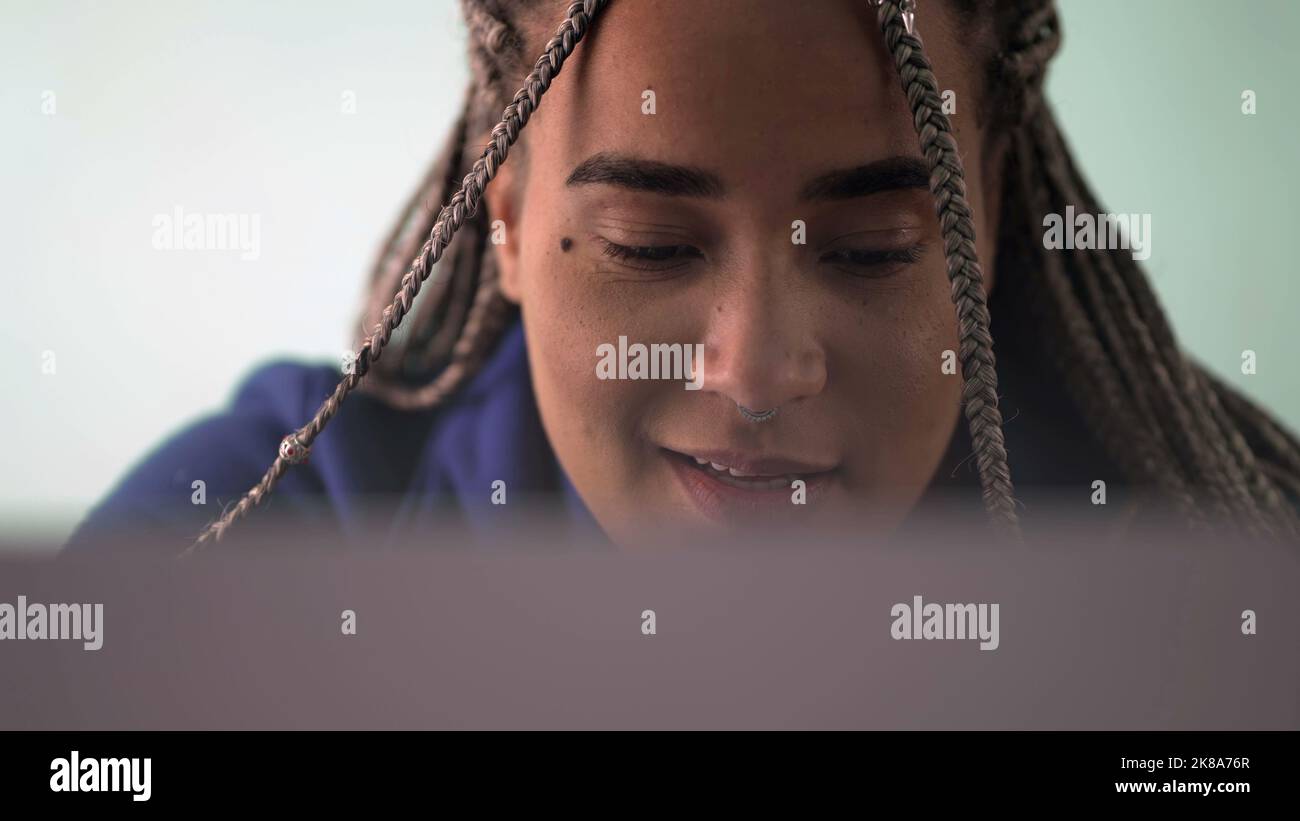 African American woman closeup face smiling searching online on laptop ...
