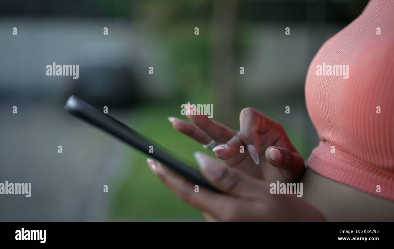 Closeup female hands holding tablet device touching screen with finger ...