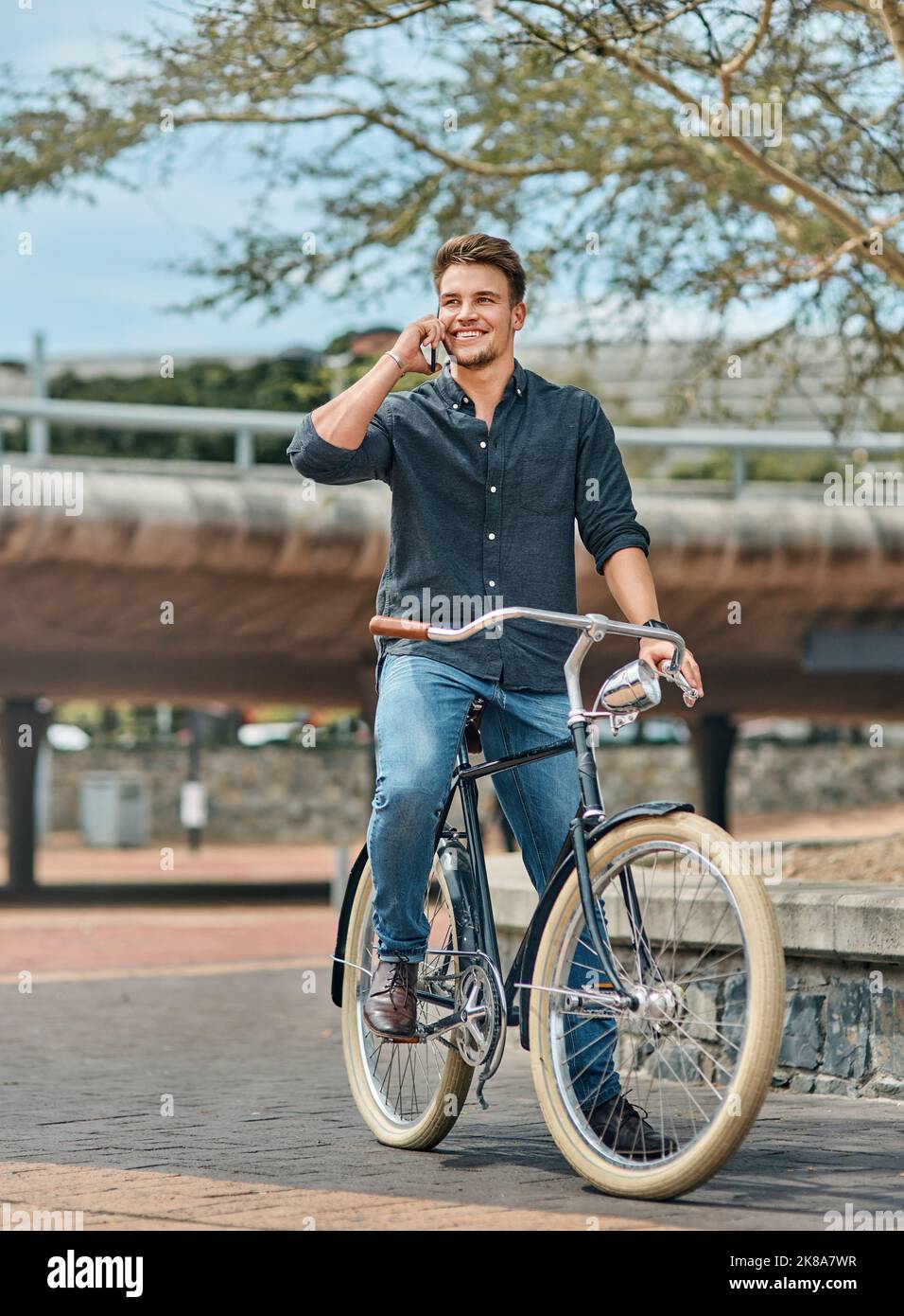 The whole world at your wheels. a young male student using his mobile ...