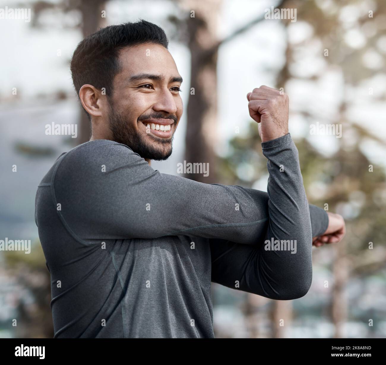 The perfect morning for a run. a handsome young man stretching before ...
