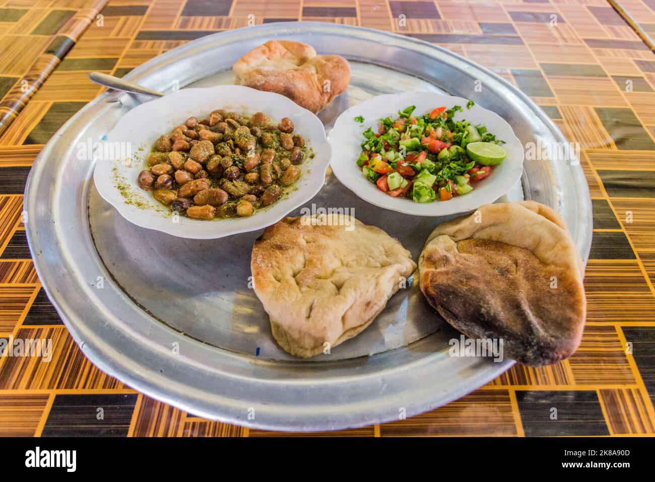 Traditional meal in Sudan - fuul (stew of cooked fava beans), salad and ...