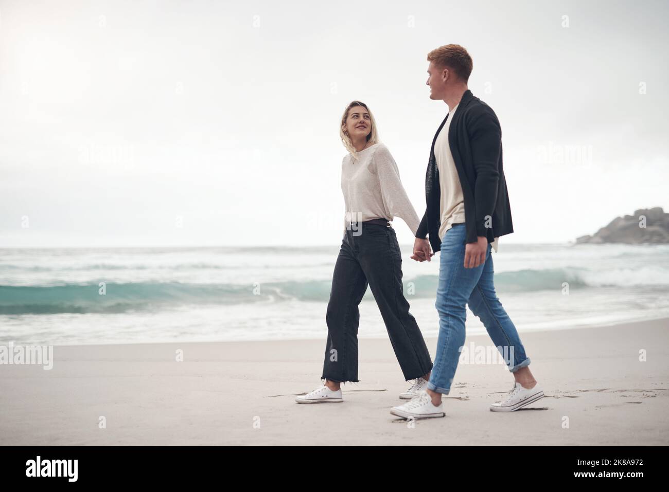 A day at the beach is just what we needed. a couple holding hands while ...