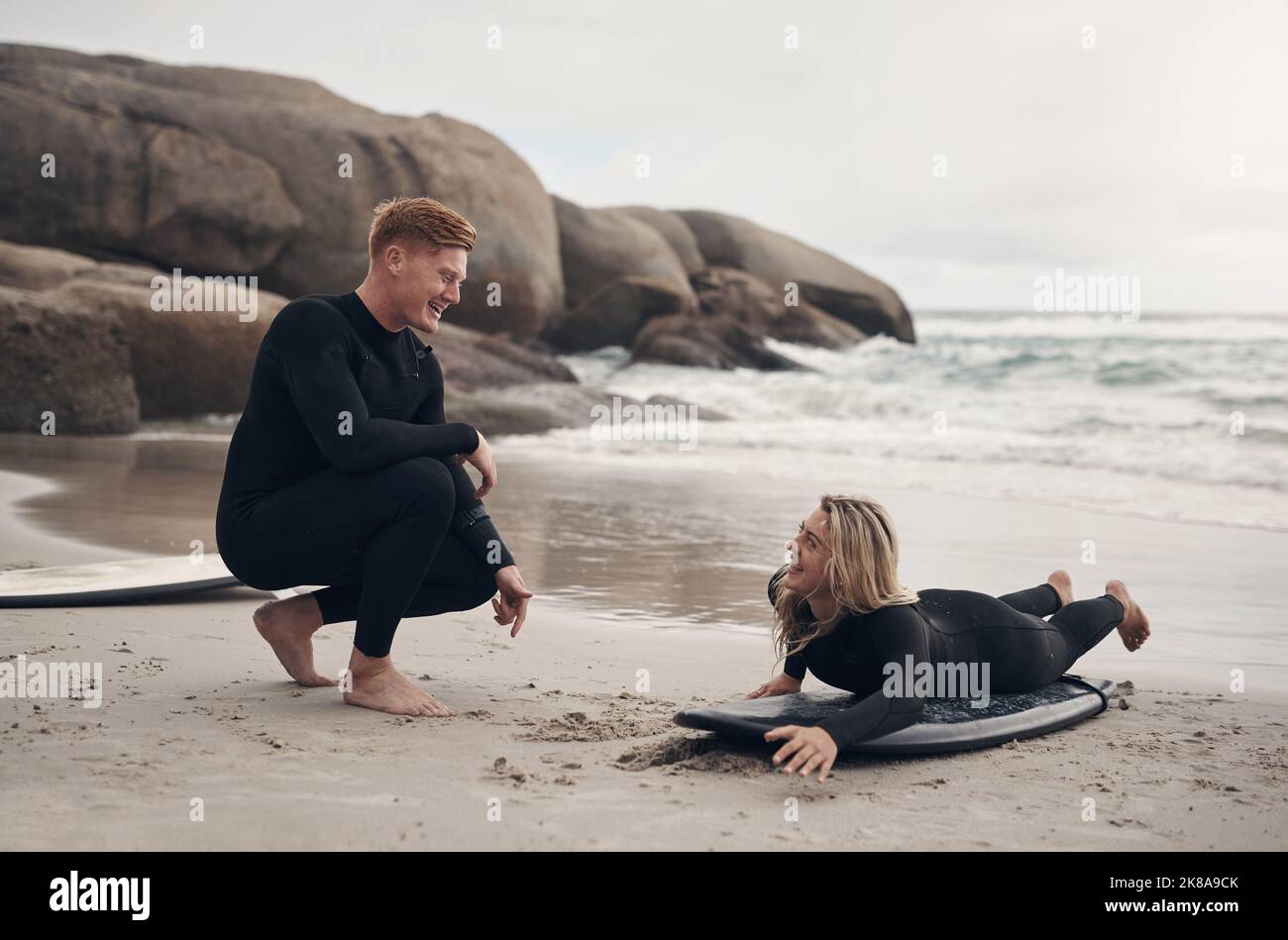 Youre catching on fast. a man giving a woman surfing lessons on the ...
