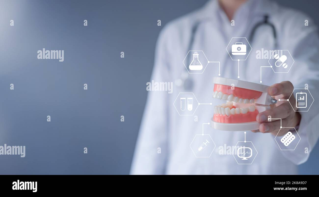Dental care concept. Dentist with plastic teeth model and health icon ...