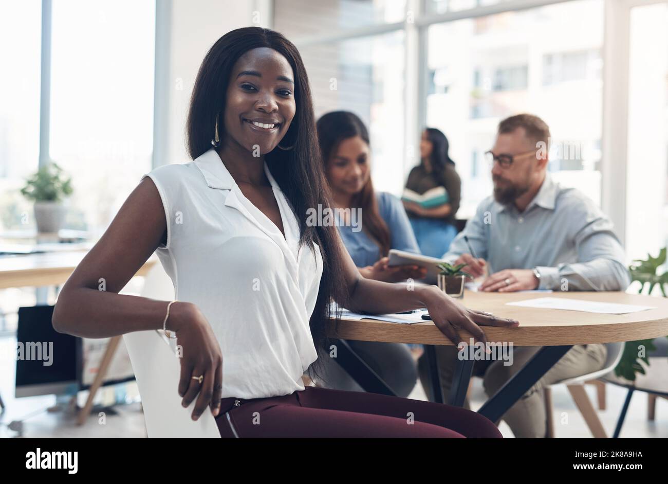 I love being a part of this team. Cropped portrait of an attractive young businesswoman sitting ...