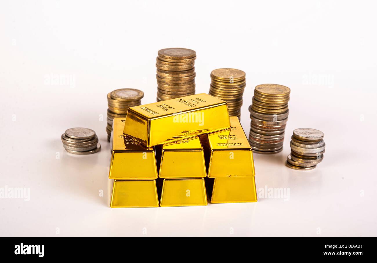 Pile of pure shiny gold bars with coins in the background Stock Photo ...