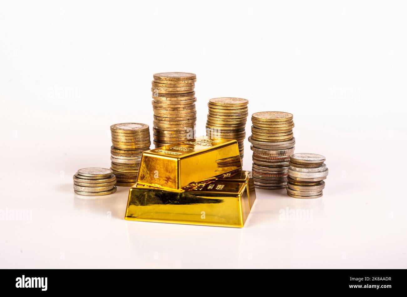 Shiny gold bar with coins in white background - financial concept Stock Photo - Alamy