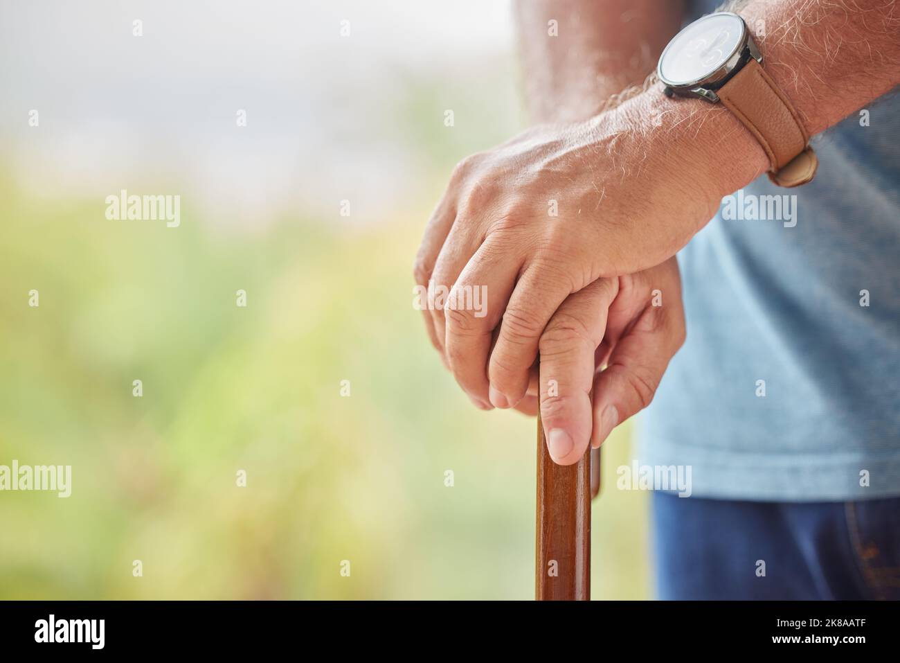 Disability, senior man and hands on stick for support while walking in ...