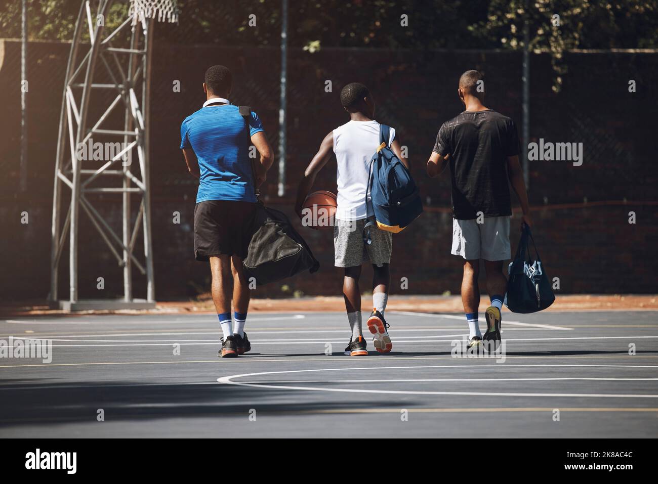 Basketball court, men and friends walking in sports ground for athlete ...