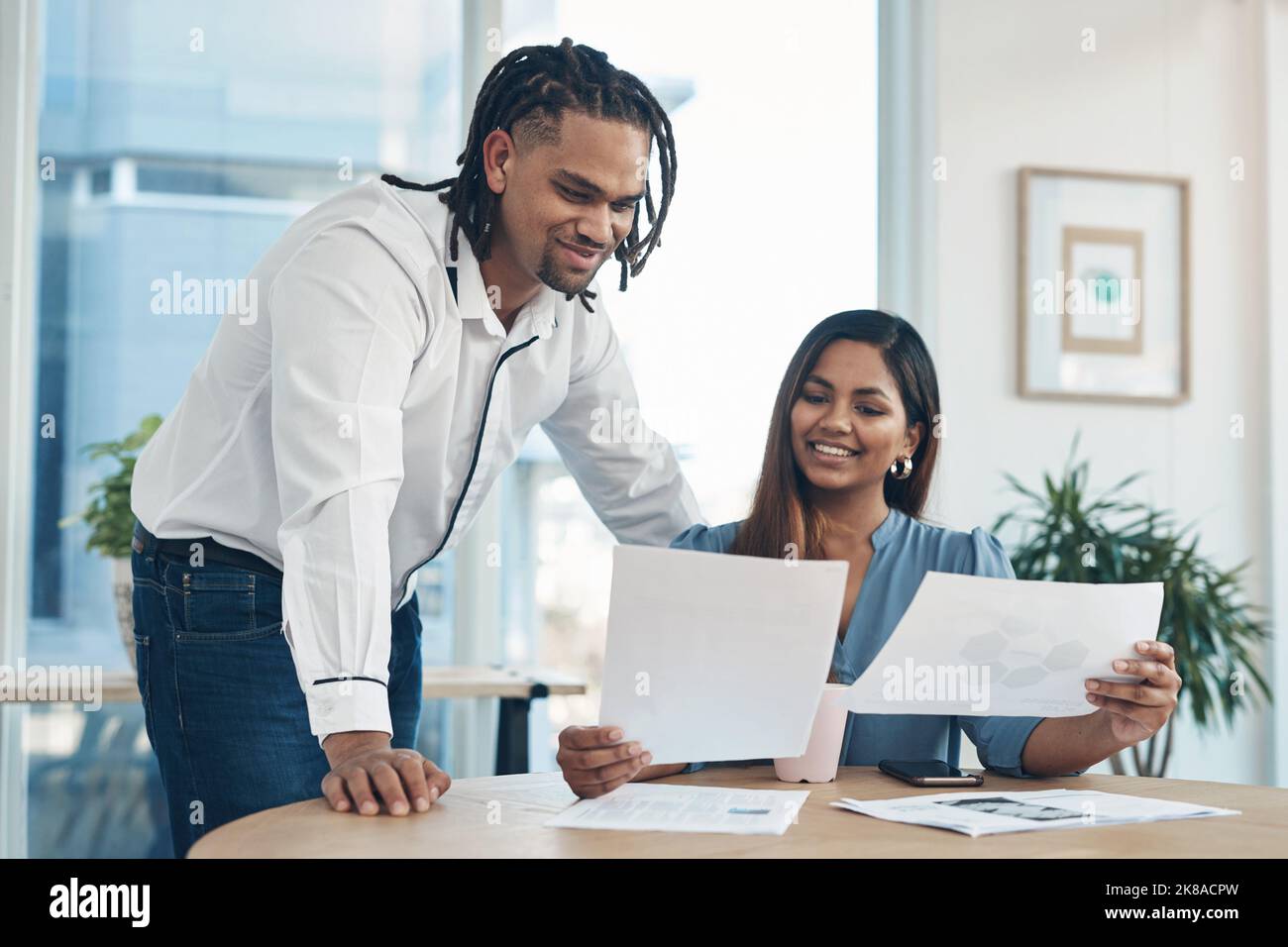 All looks good so far. two businesspeople going through paperwork ...
