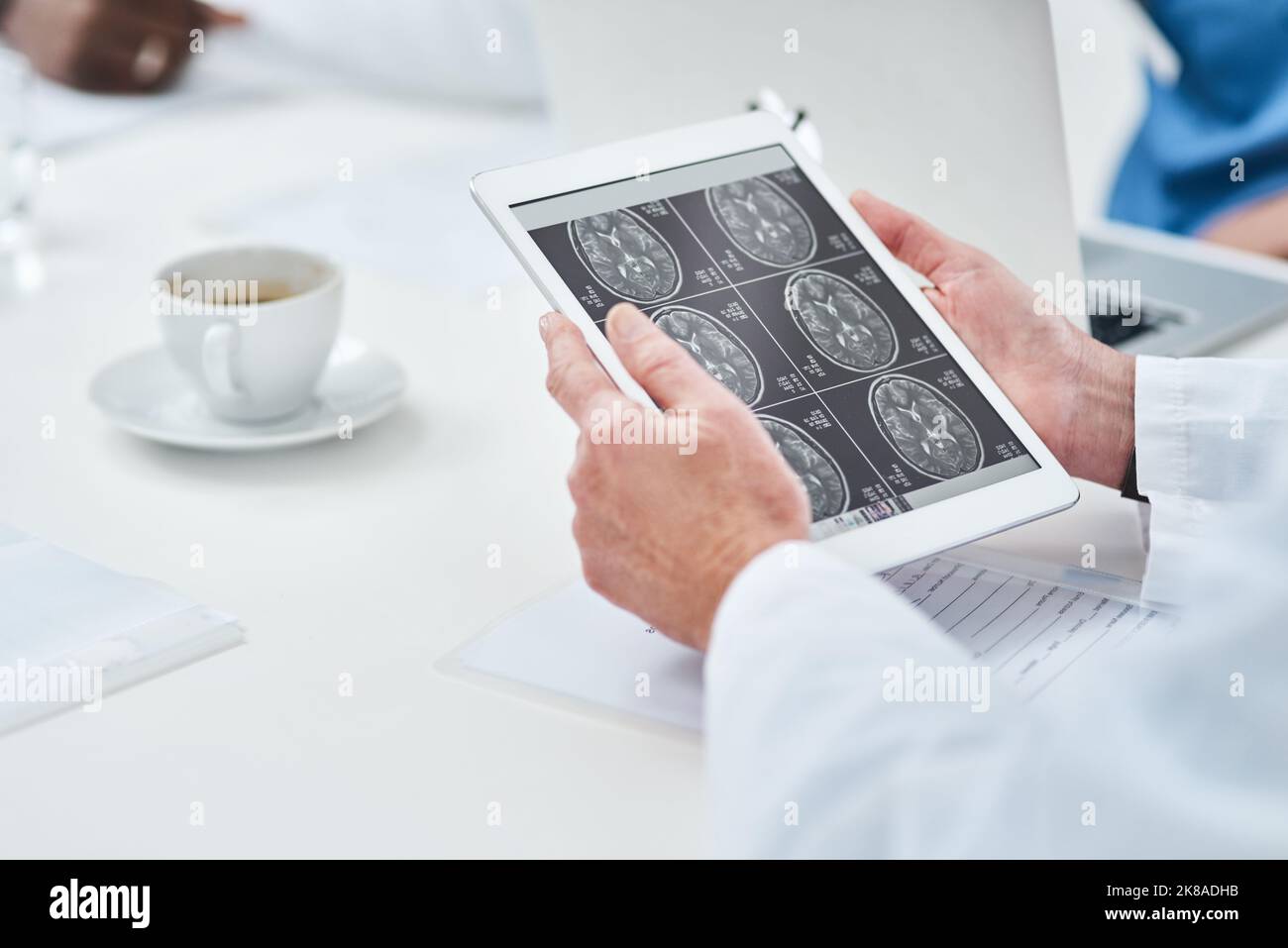 Reading into the scans. Closeup shot of an unrecognisable doctor ...