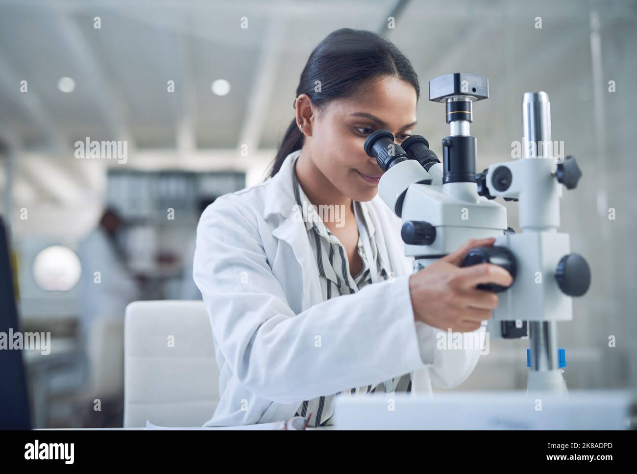 Science opens the door to a better tomorrow. a young scientist using a ...