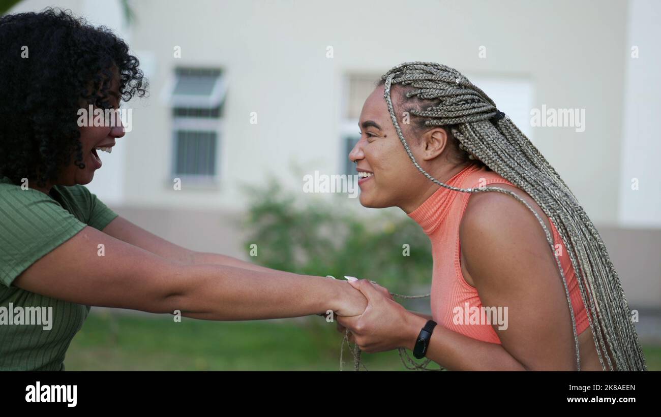 Happy friends hugging in reunion. Two people hug and embrace outside ...