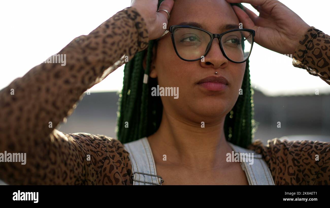 One young black latina young woman playing box braided hairstyle ...