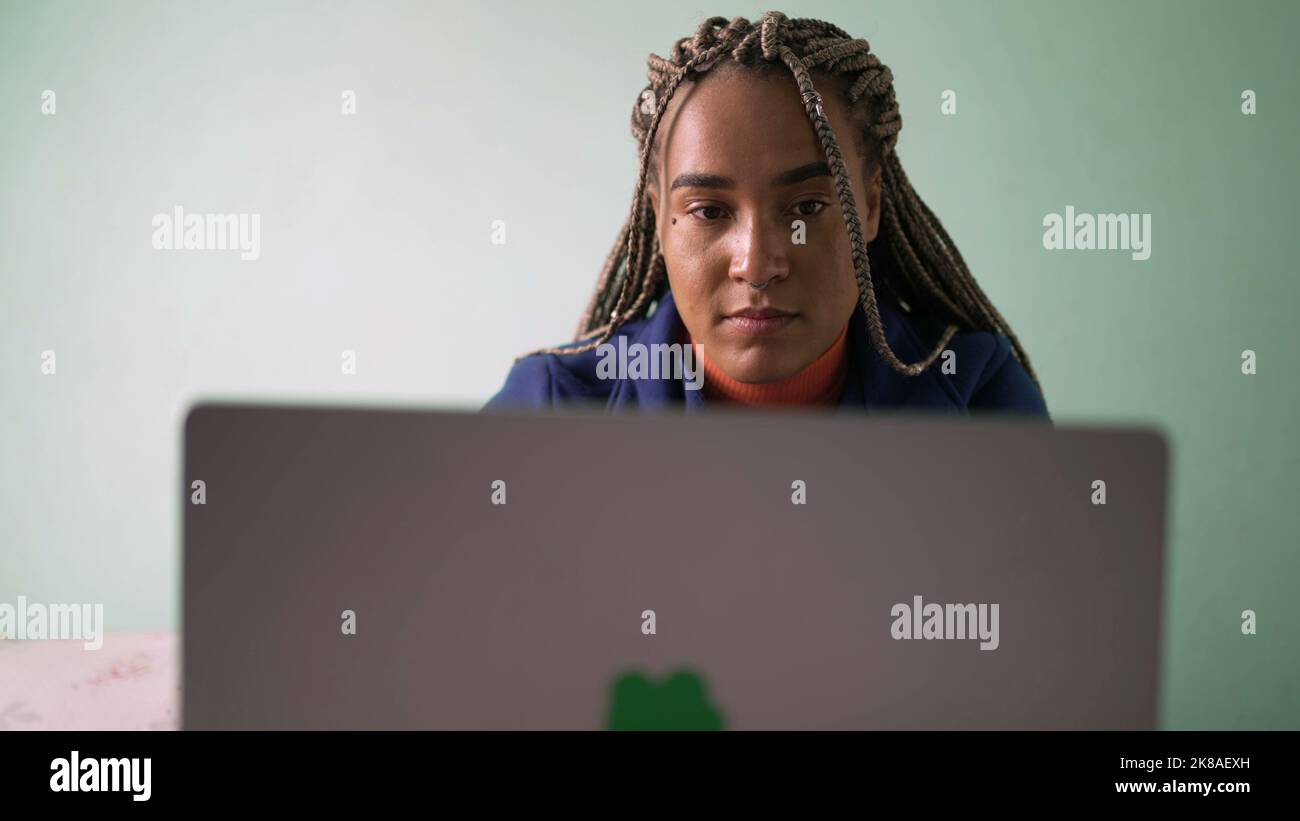 One young black woman opening laptop screen. A Brazilian latin female ...