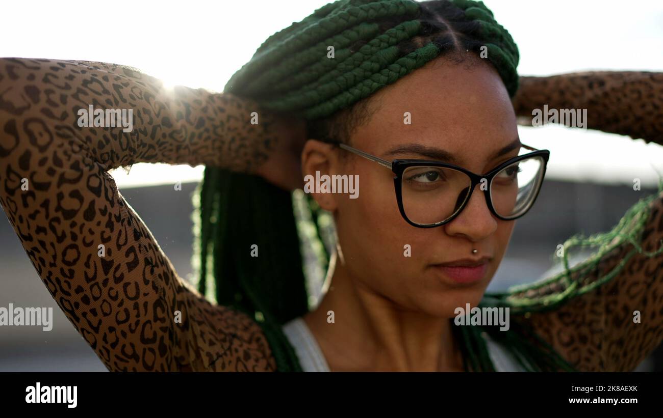 One young black latina young woman playing box braided hairstyle ...