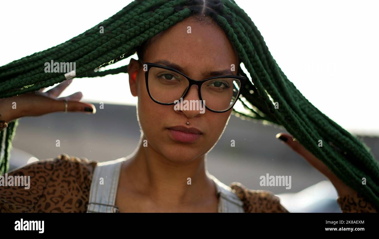 One young black latina young woman playing box braided hairstyle ...