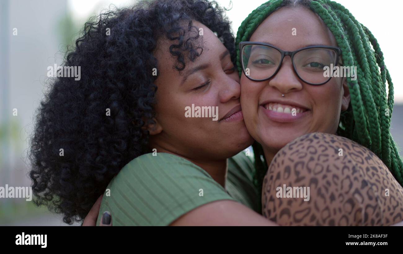 Two black sisters showing love and affection. African American sibling ...