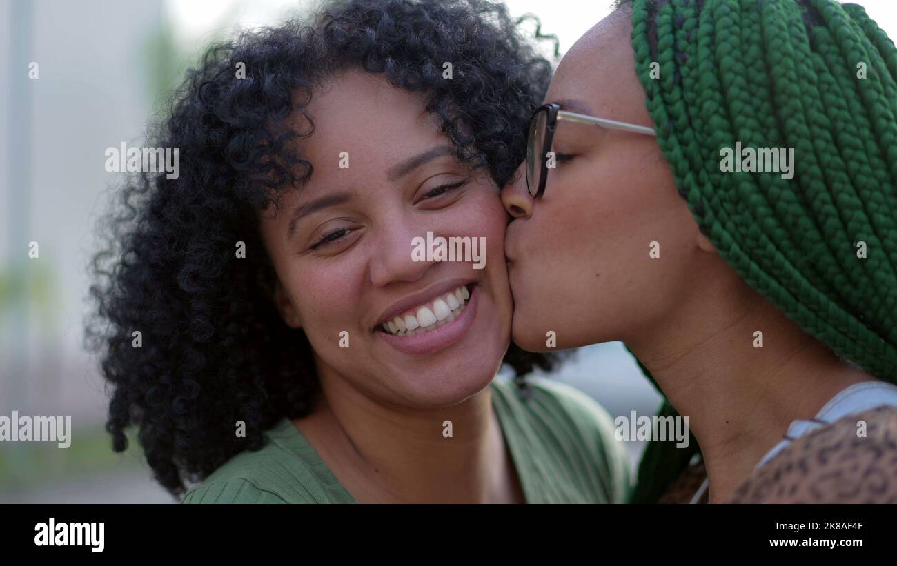 Two black sisters showing love and affection. African American sibling ...