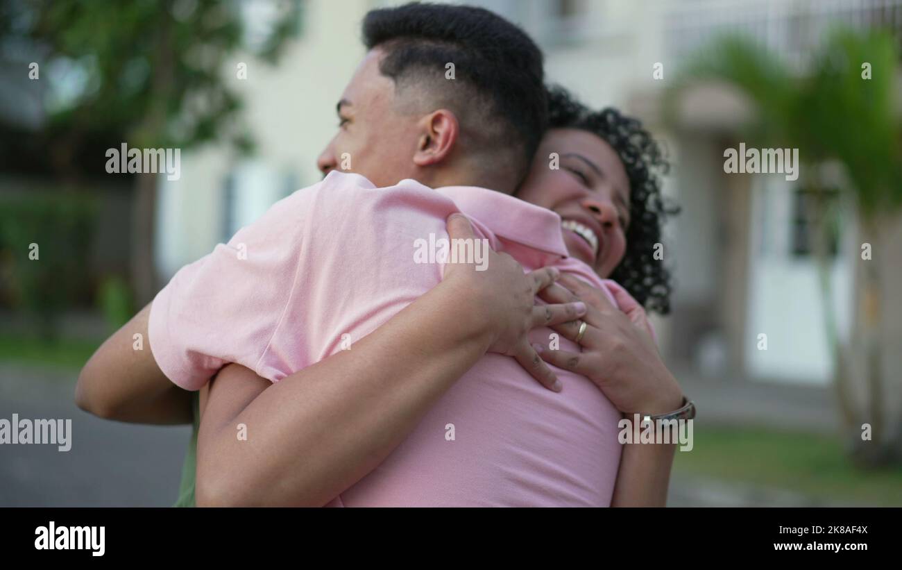 Two happy people embracing celebrating reunion. Young woman hugging ...