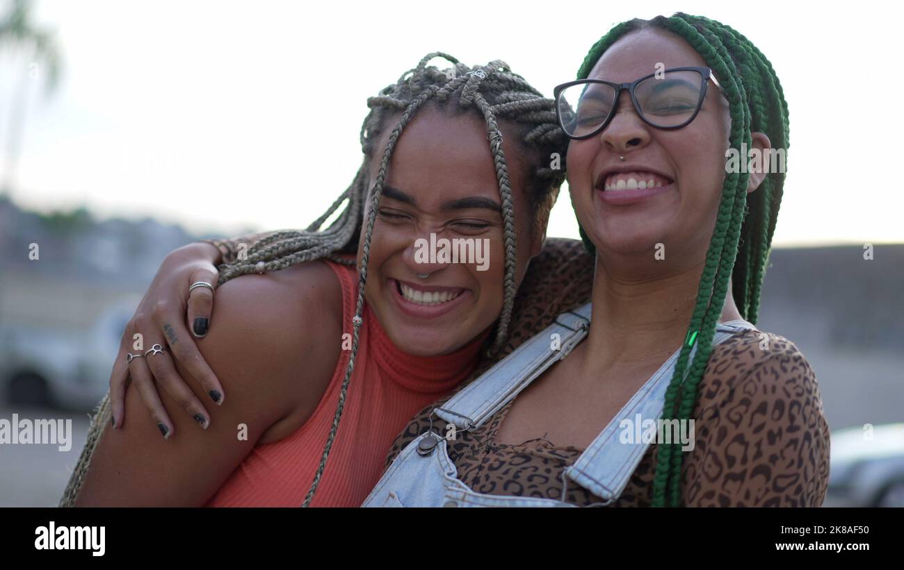 Two hispanic black women embrace. South American Brazilian sisters ...