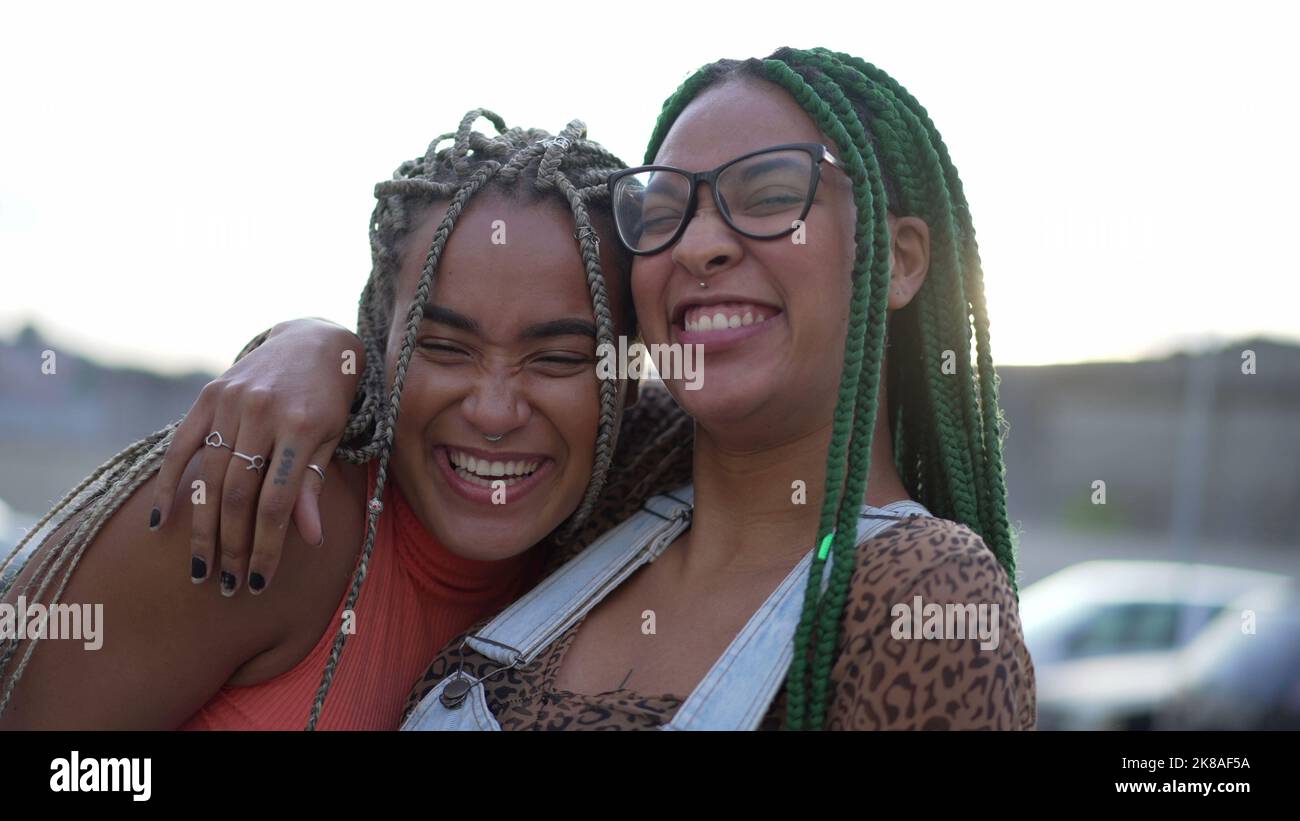 Two hispanic black women embrace. South American Brazilian sisters ...