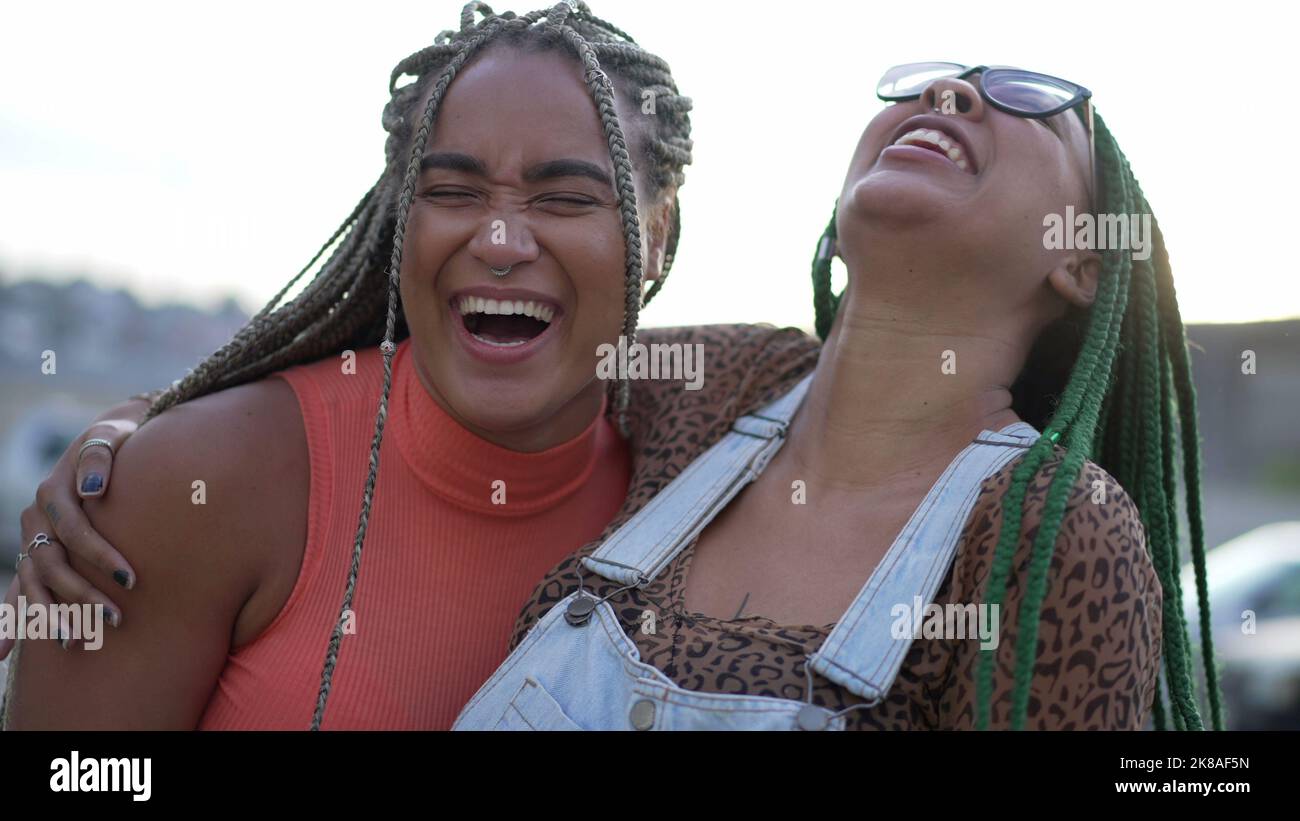 Two hispanic black women embrace. South American Brazilian sisters ...