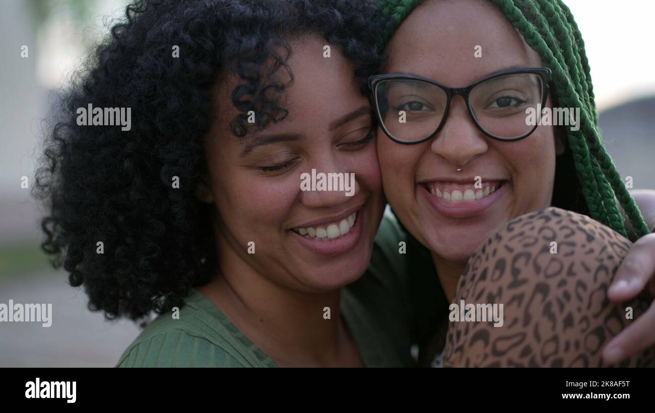 Two young black women faces cheek to cheek. South American adult girls ...