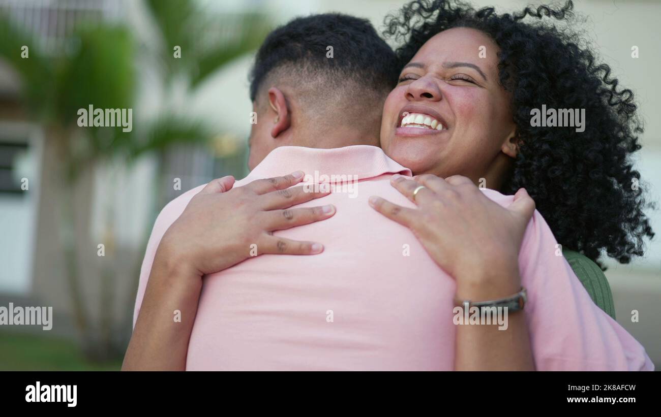 Young woman embracing male friend. Authentic real life reunion ...