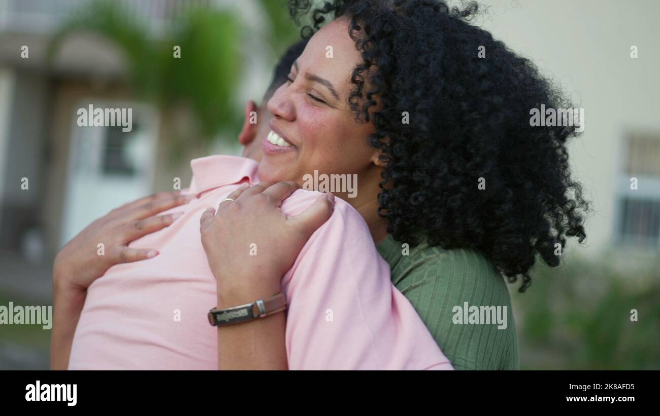 Young woman embracing male friend. Authentic real life reunion ...