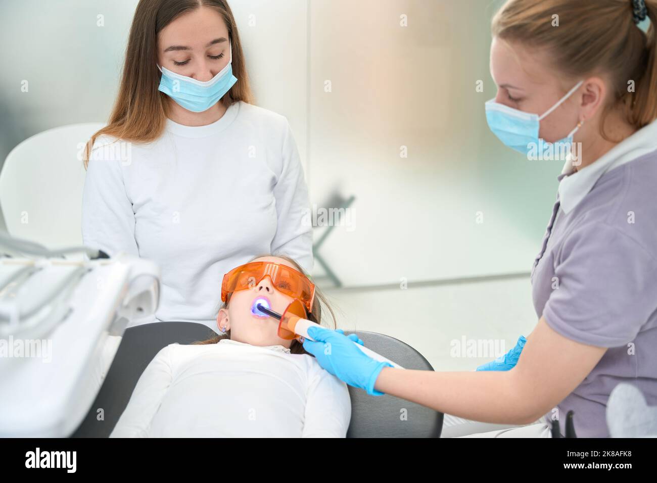 Preteen child getting photopolymer filling in front teeth Stock Photo ...